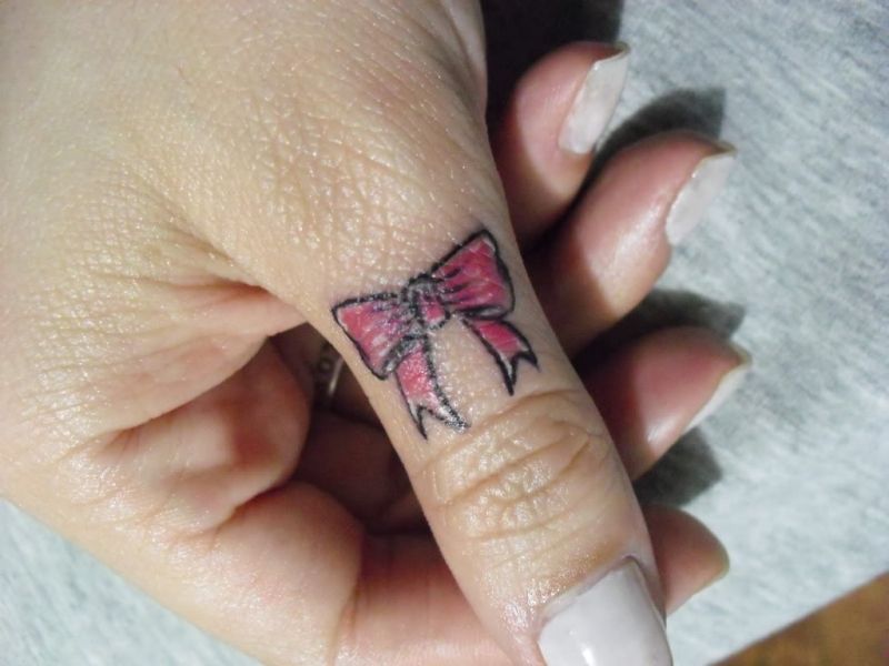Pink ribbon on finger